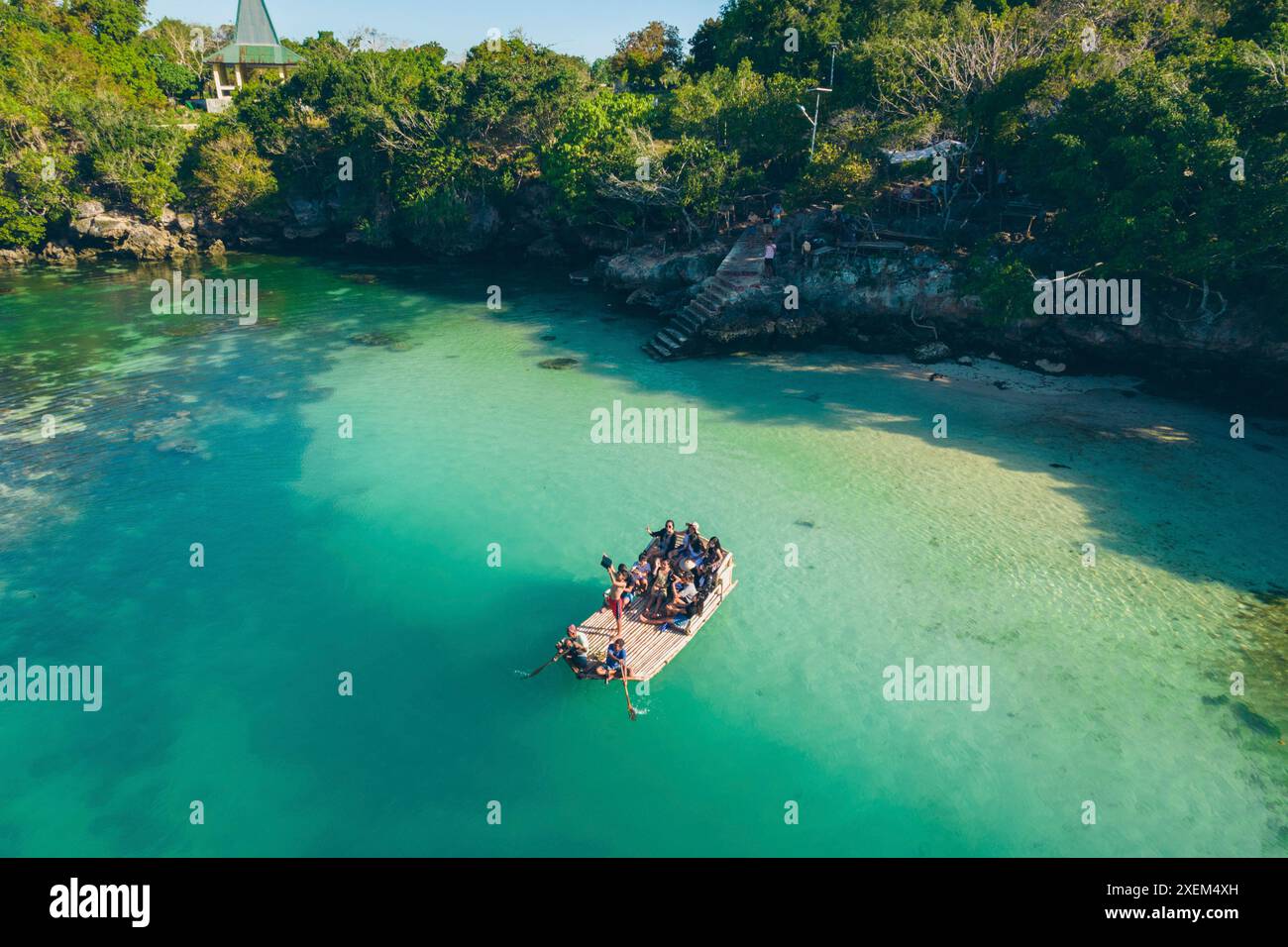 Riding on a floating platform in Walakiri lagoon; Watumbaka, Kecamatan ...
