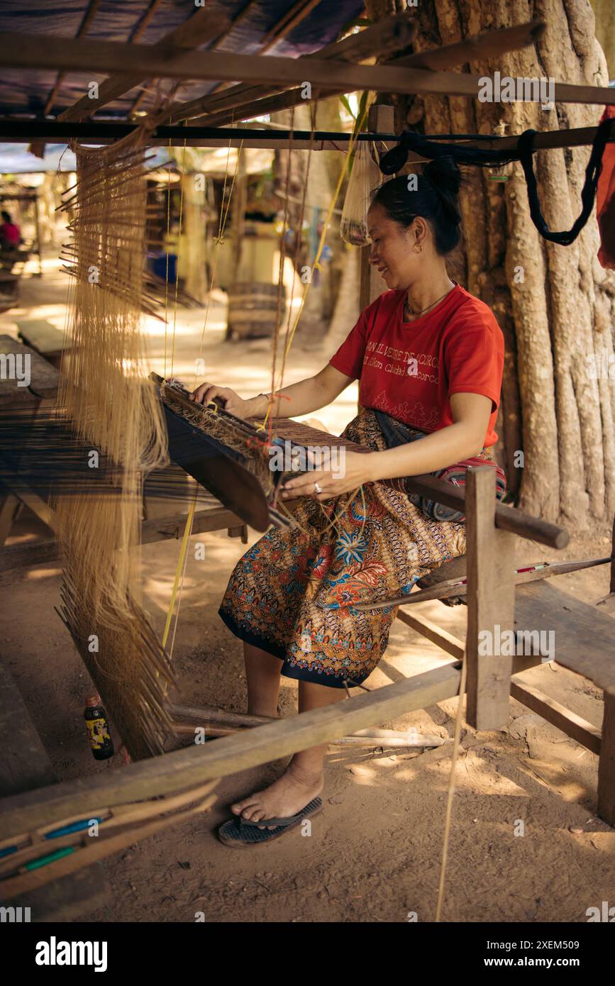 Woman using a loom in the village of Ban Phahom, Laos; Ban Phahom ...