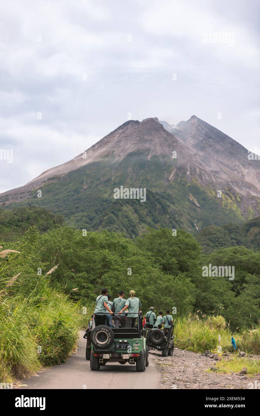 Tourists stand viewing Mount Merapi, an active stratovolcano in Central ...