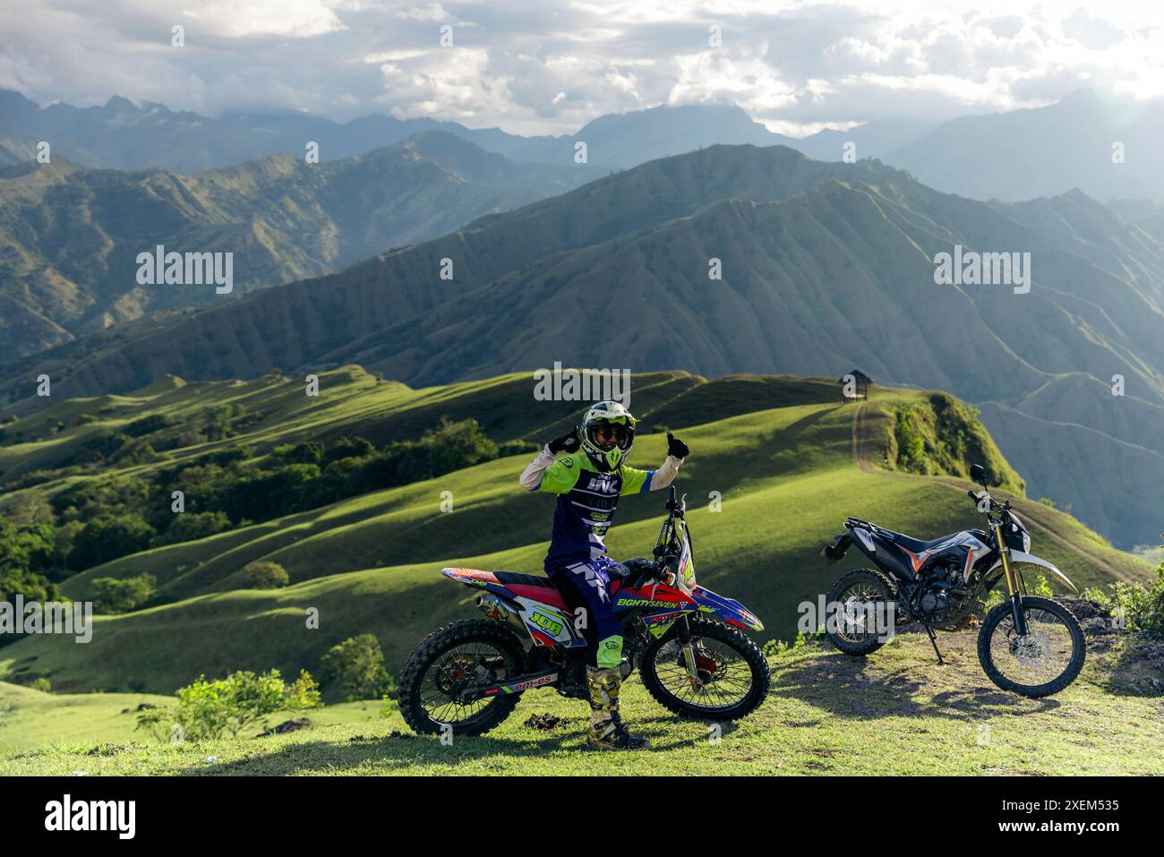 Motorbike rider poses with excitement at the beautiful awe inspiring ...
