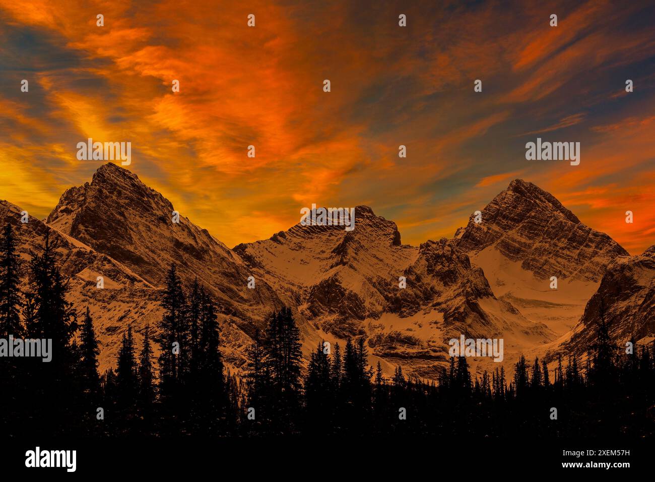 Dramatic colourful cloud formation above a snow-covered mountain range ...