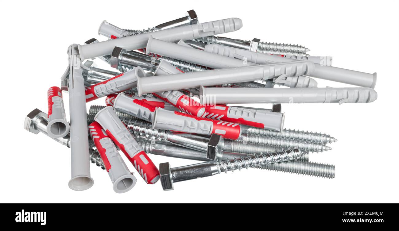 Pile of various plastic wall plugs or steel bolts isolated on white ...
