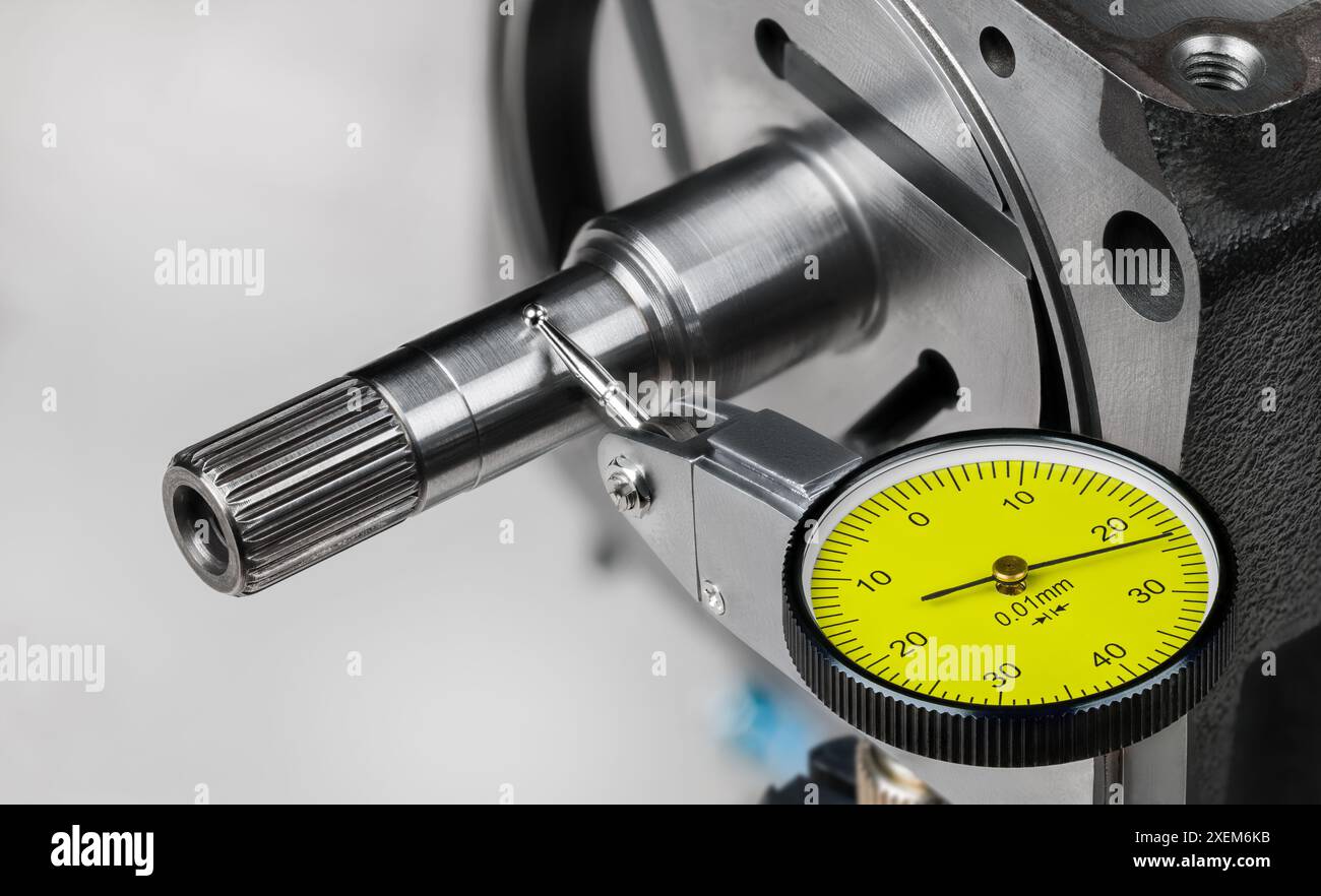 Closeup a yellow dial test indicator with metal probe on hinge and ...