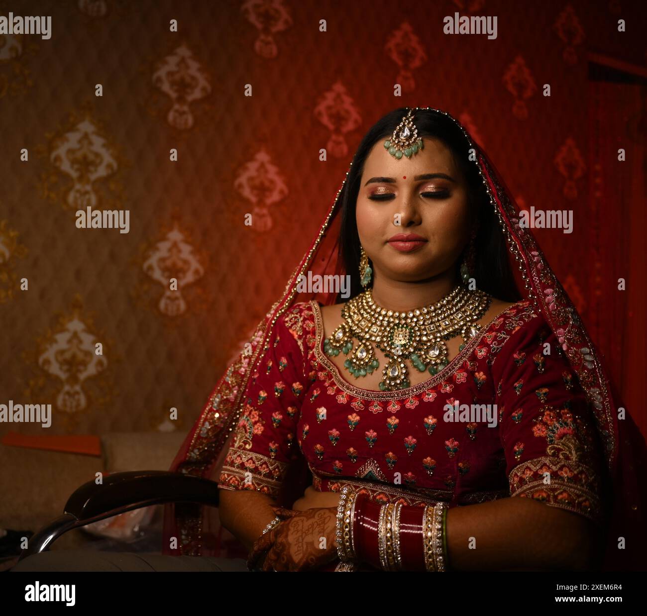 An Indian bride in traditional attire, adorned with intricate jewelry ...