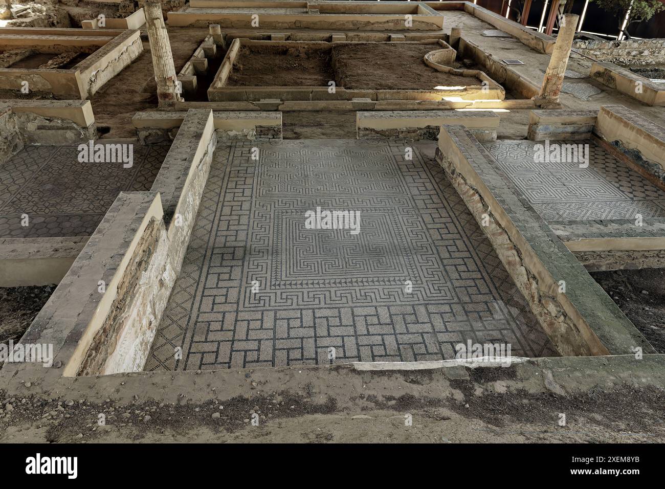 A well-preserved Roman mosaic depicting intricate patterns and faded ...