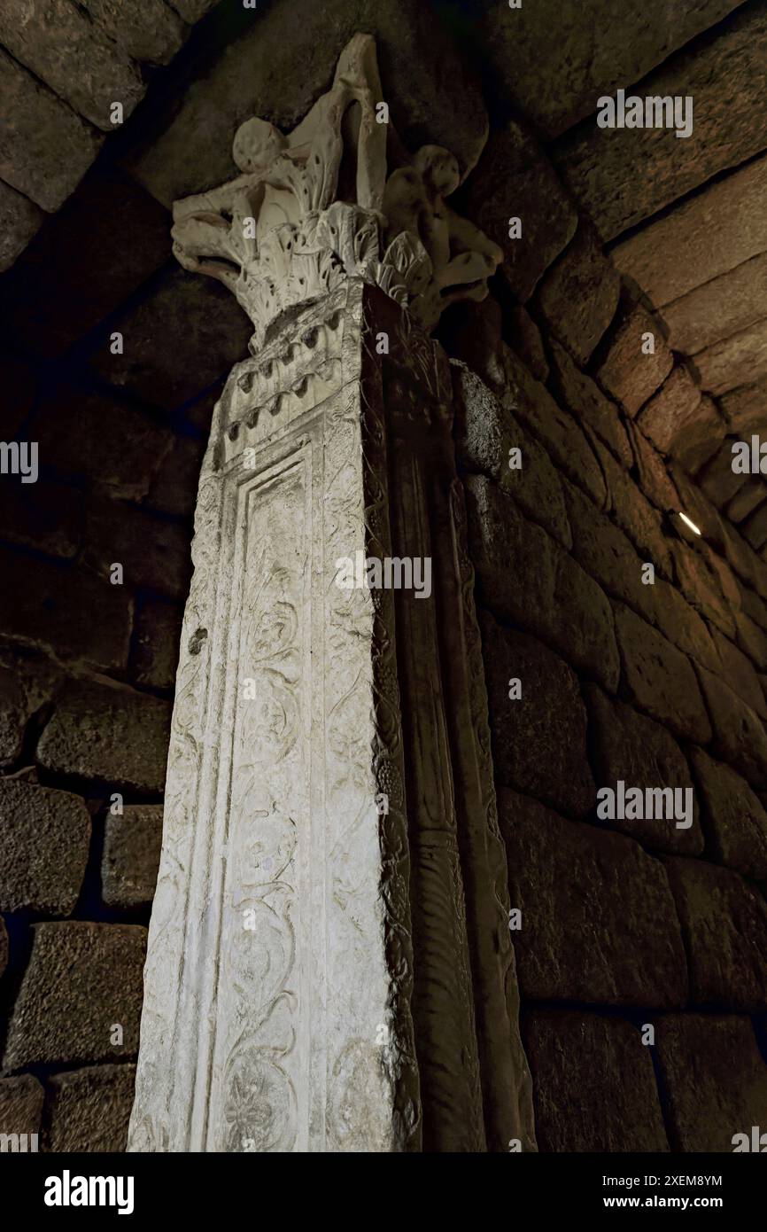 A dimly lit stone passageway leading to an ancient structure in Merida ...