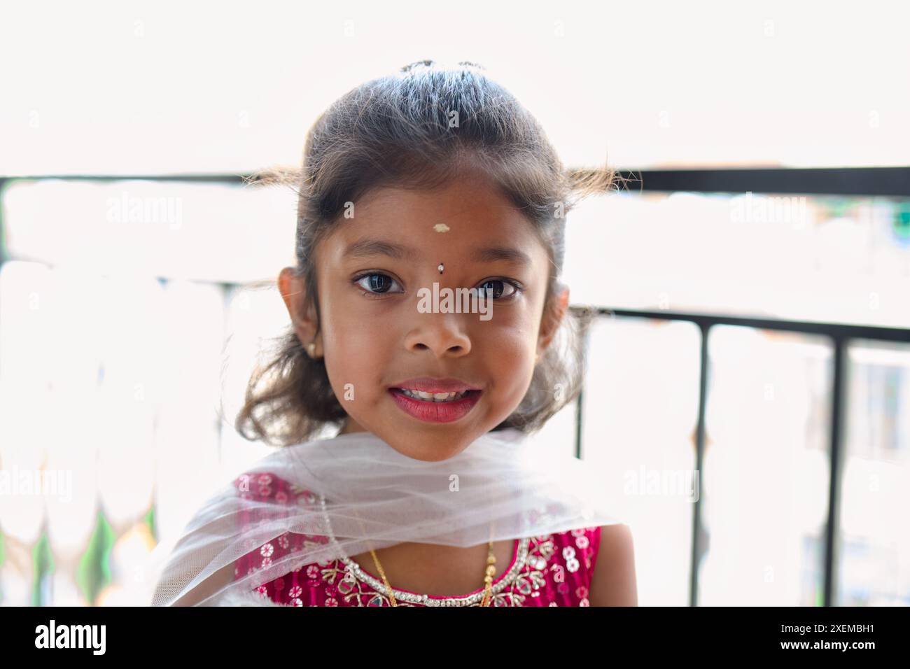 A captivating close-up portrait of a young Indian girl kid, her eyes ...
