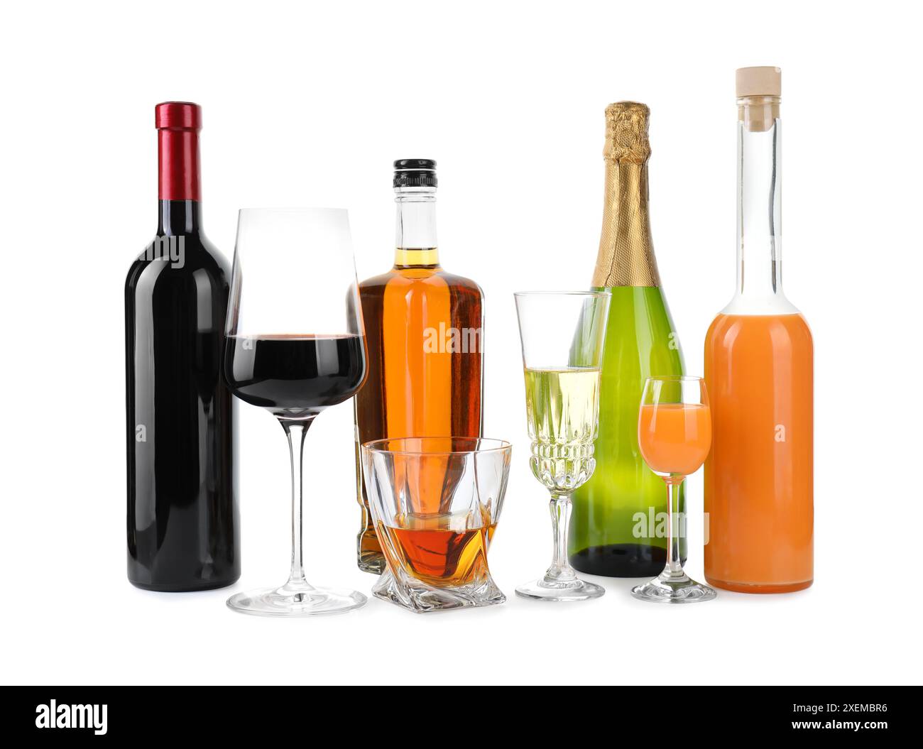 Bottles and glasses with different alcoholic drinks isolated on white ...