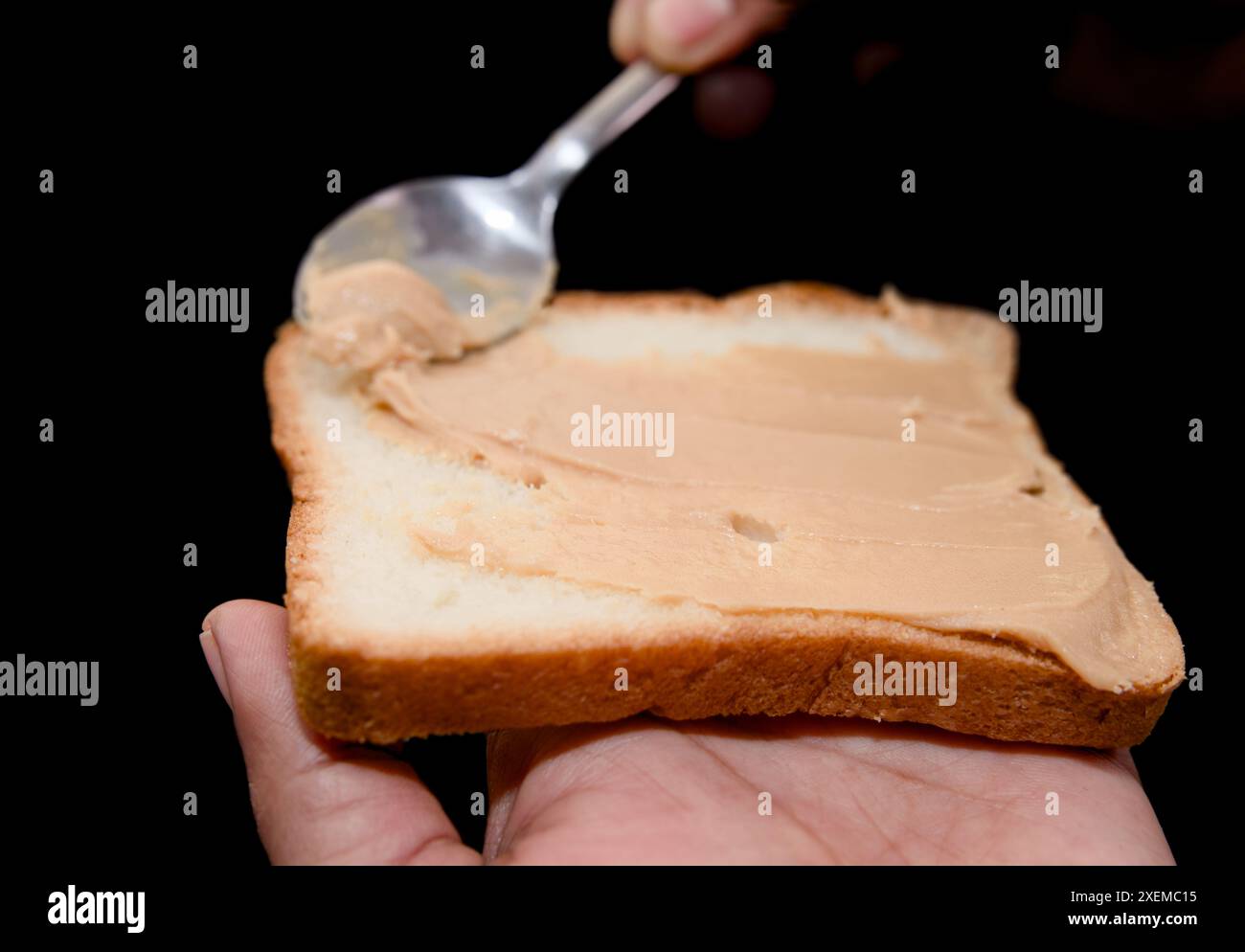 A close-up photo of a delicious spread of creamy peanut butter being ...