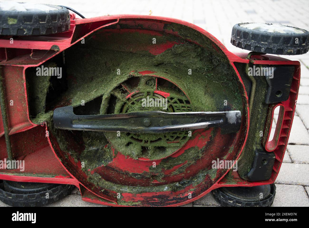 Dirty Electric lawn mower with a blunt blade Stock Photo - Alamy