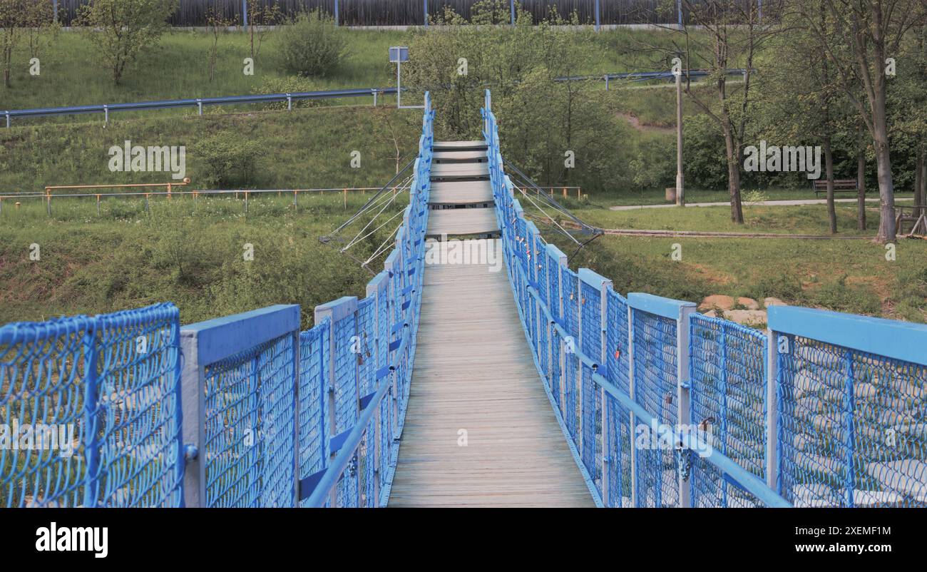 A pedestrian overhead bridge over the river Stock Photo - Alamy