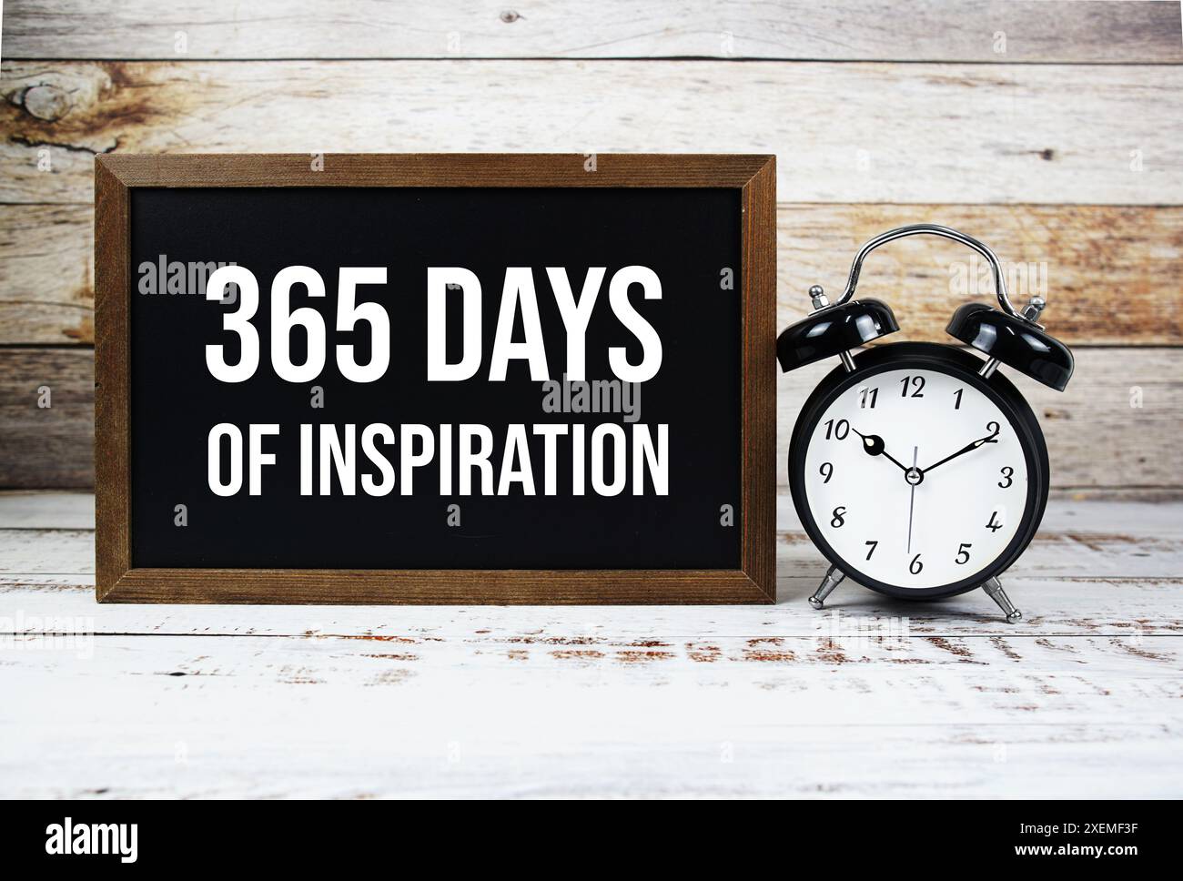 365 days of inspiration quotes text message and alarm clock on wooden ...