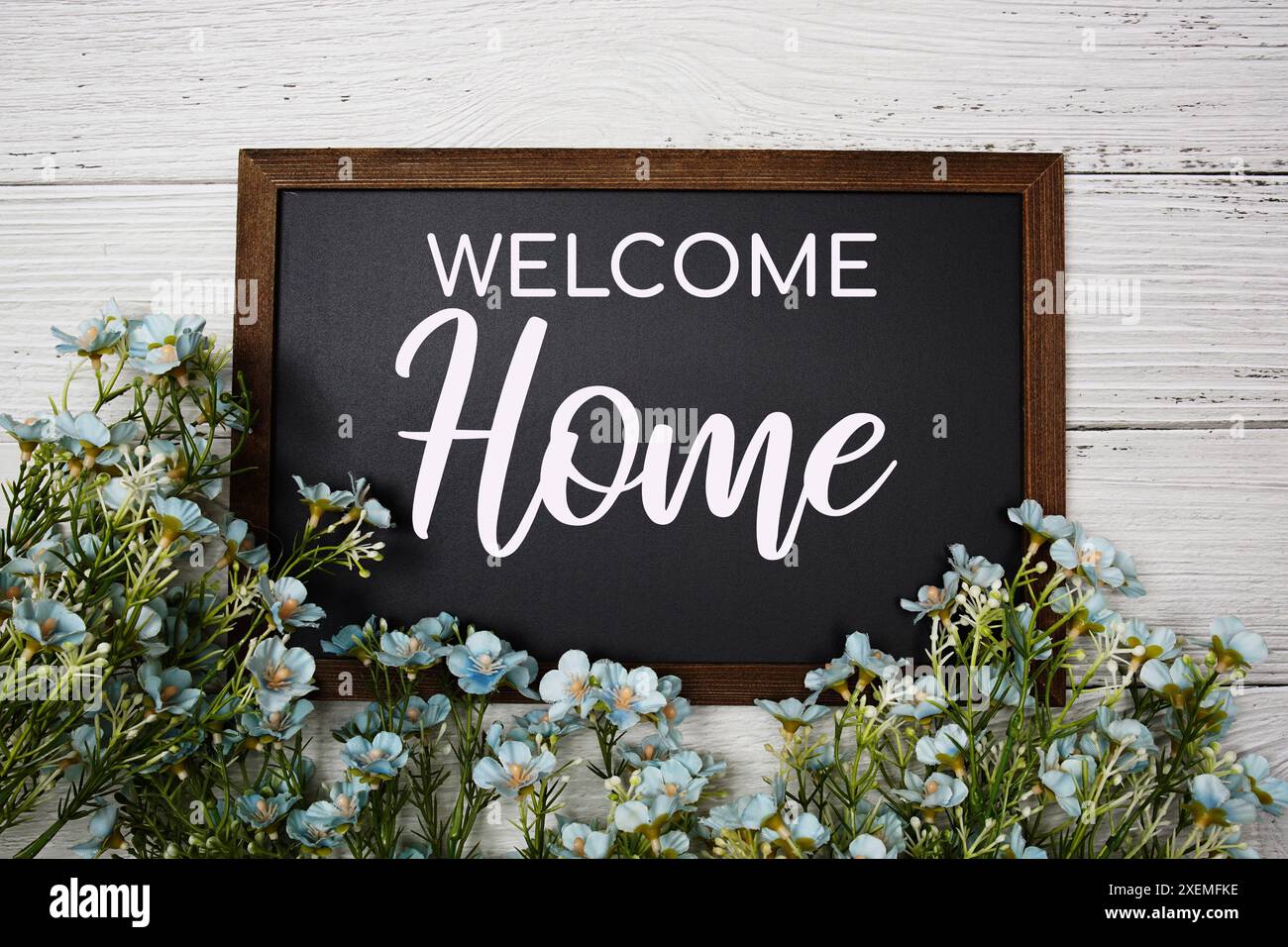 Welcome Home text on chalkboard with flowers decoration top view on ...