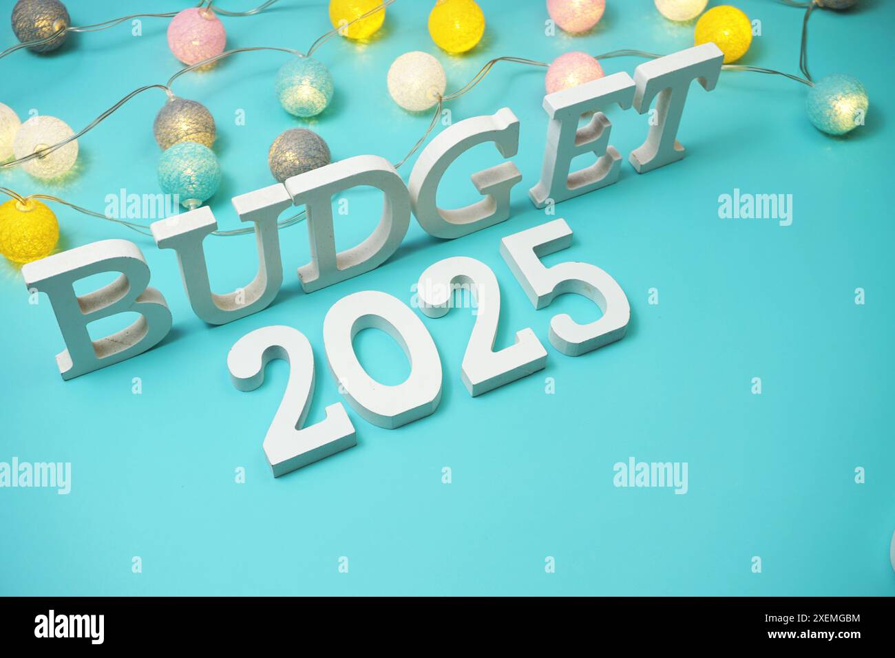 Budget 2025 alphabet letters with LED cotton balls decoration on blue ...