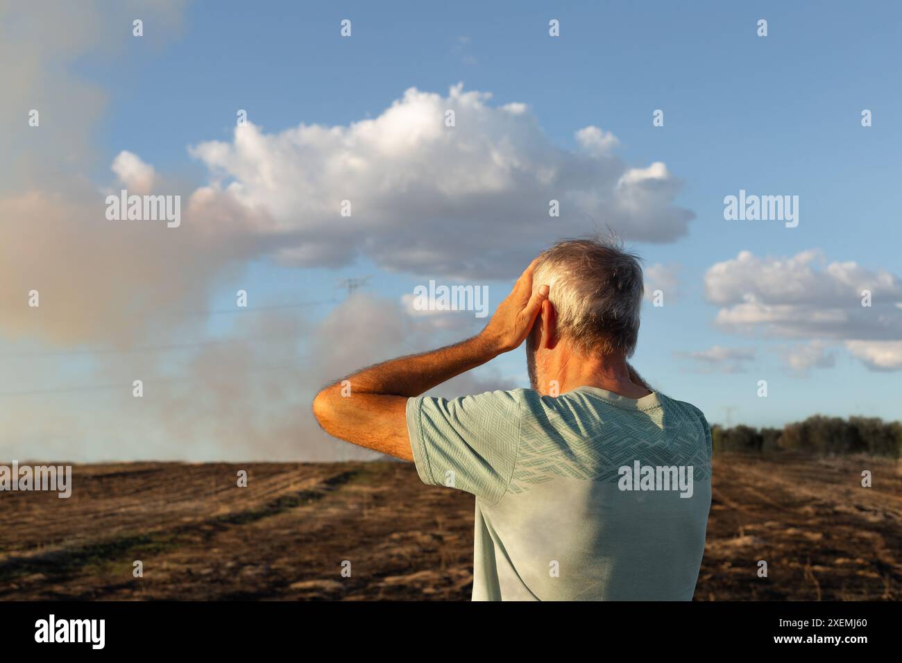 Close-up of man who is on his back and has his hands on his head ...