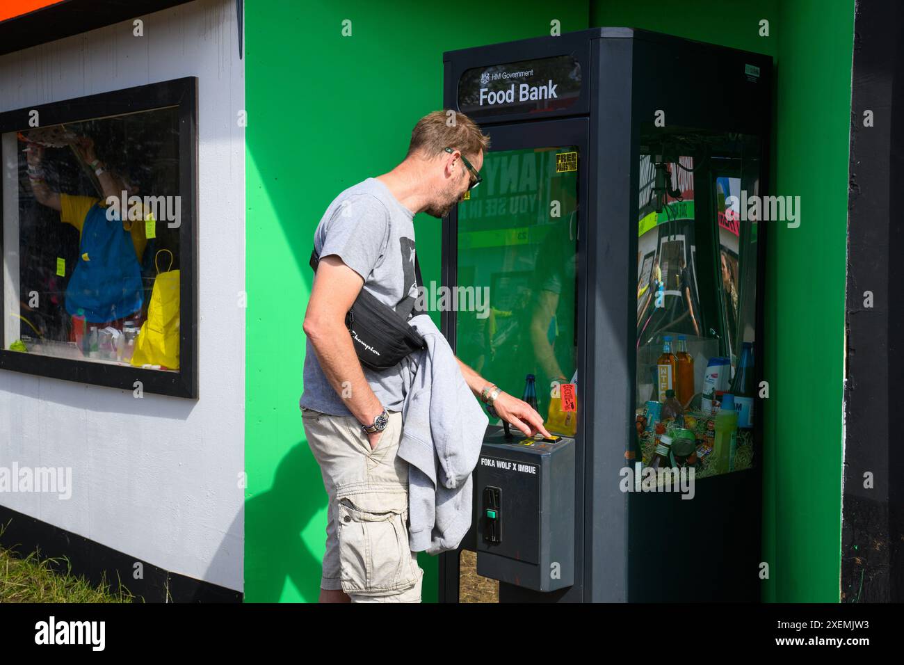 London, UK. 28 June 2024. Festivalgoers look at a ‘food bank ...