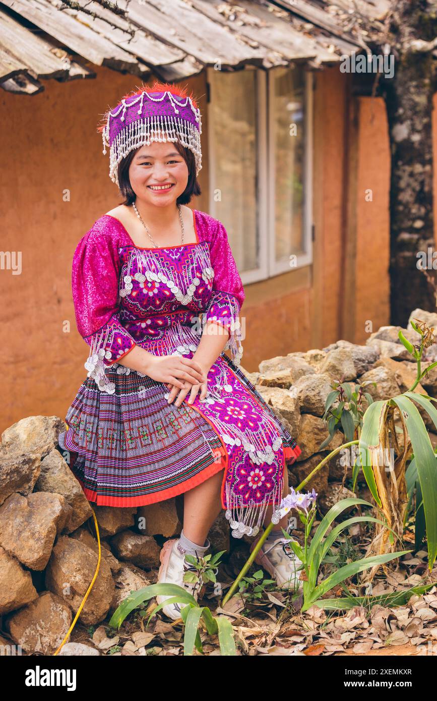 Outdoor portrait of a young Vietnamese woman in a traditional dress ...