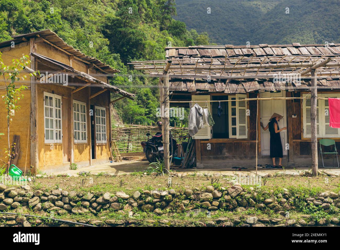 Woman outside her home in the Vietnamese countryside; Ngoc Chien, Muong ...