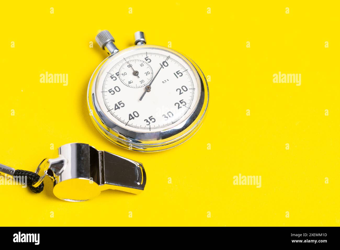 Stopwatch and whistle on a yellow background. Time management concept ...