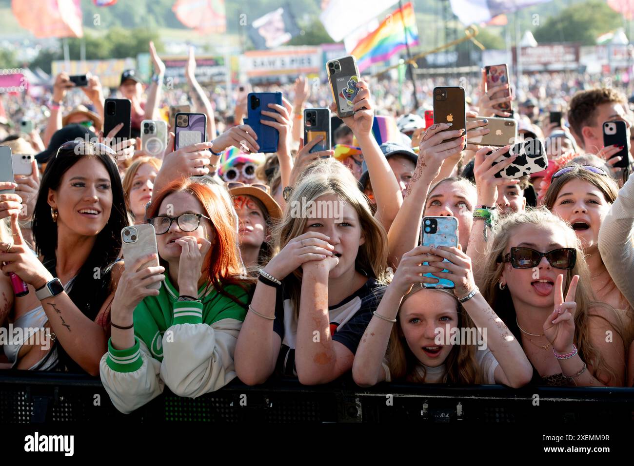 Glastonbury, UK. Day 3, 28 June 2024. Young festival goers wait for ...