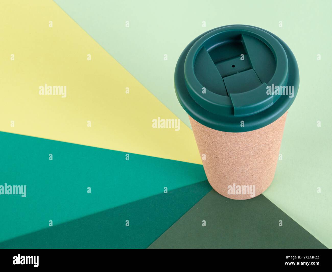 Reusable cup on a background with different shades of green ...