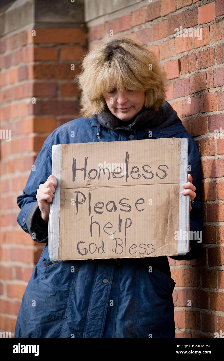 Homeless woman holding a cardboard sign for help; Undadilla, Nebraska ...