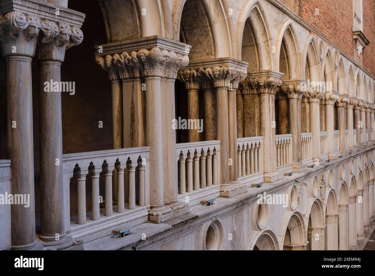 Close-up view of the decorative stone work on the columns and arches of ...