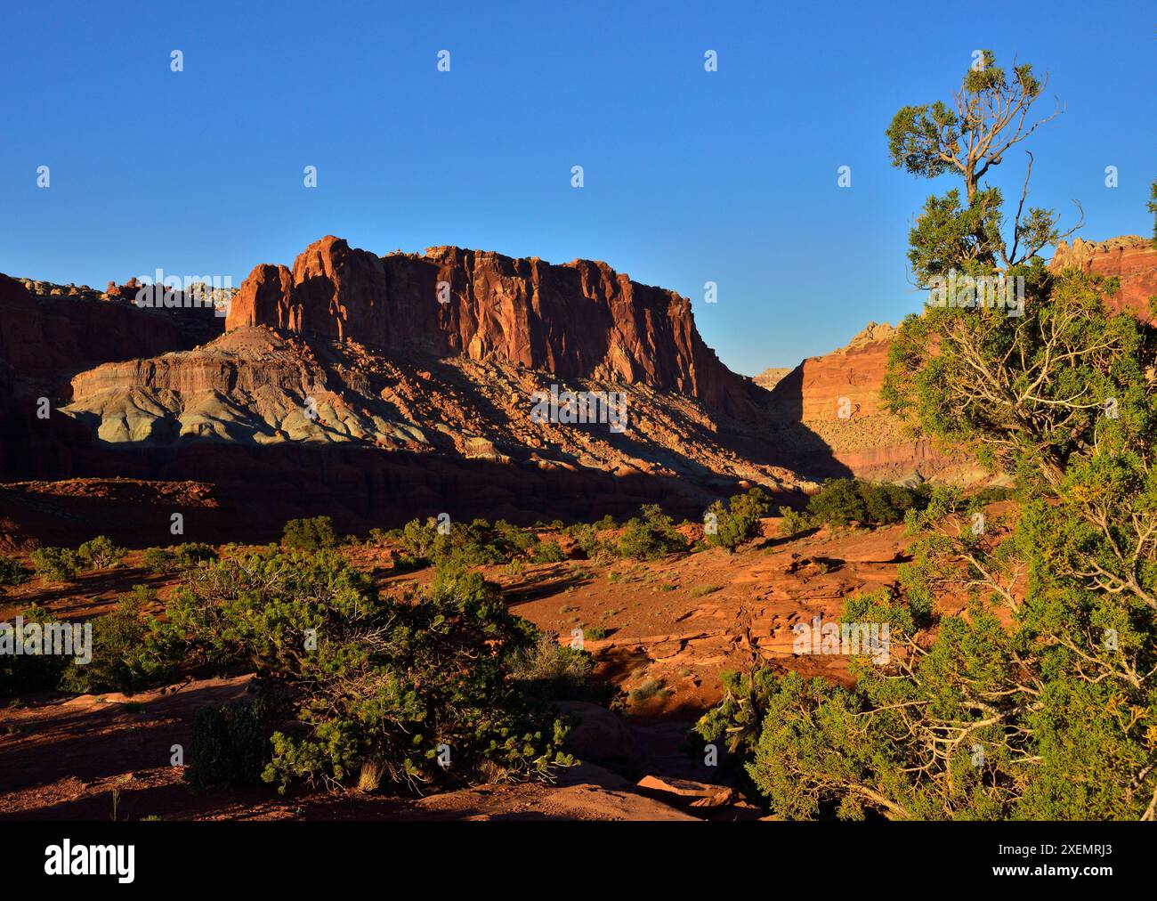 Warm sunset light over the rugged rocky landscape in Capitol Reef ...