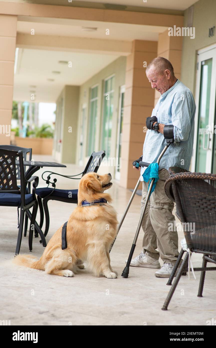 Man with forearm crutches makes a hand sign and gets assistance from ...