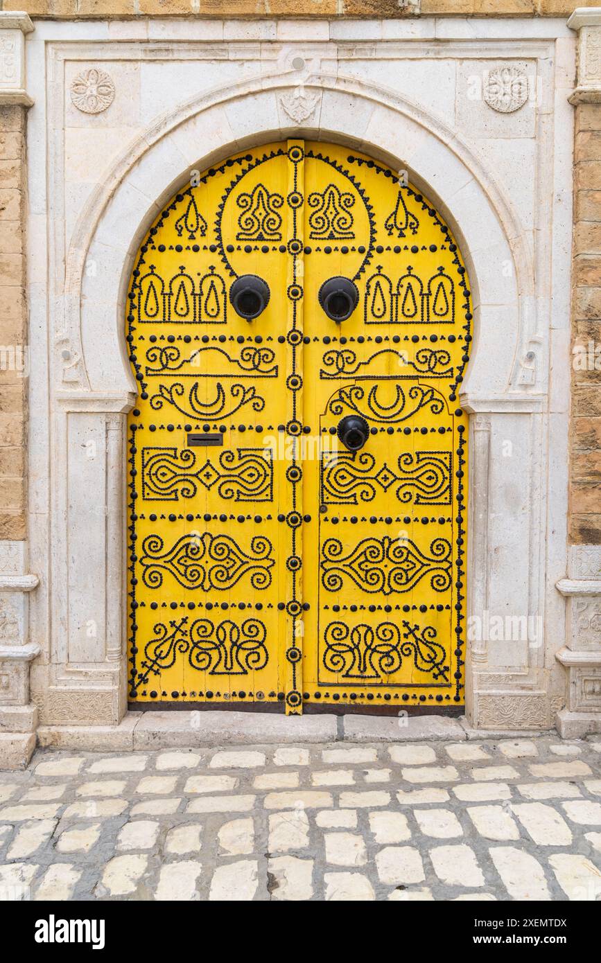 Tunis, Tunisia. A decorated door in a keyhole arch, also known as a ...