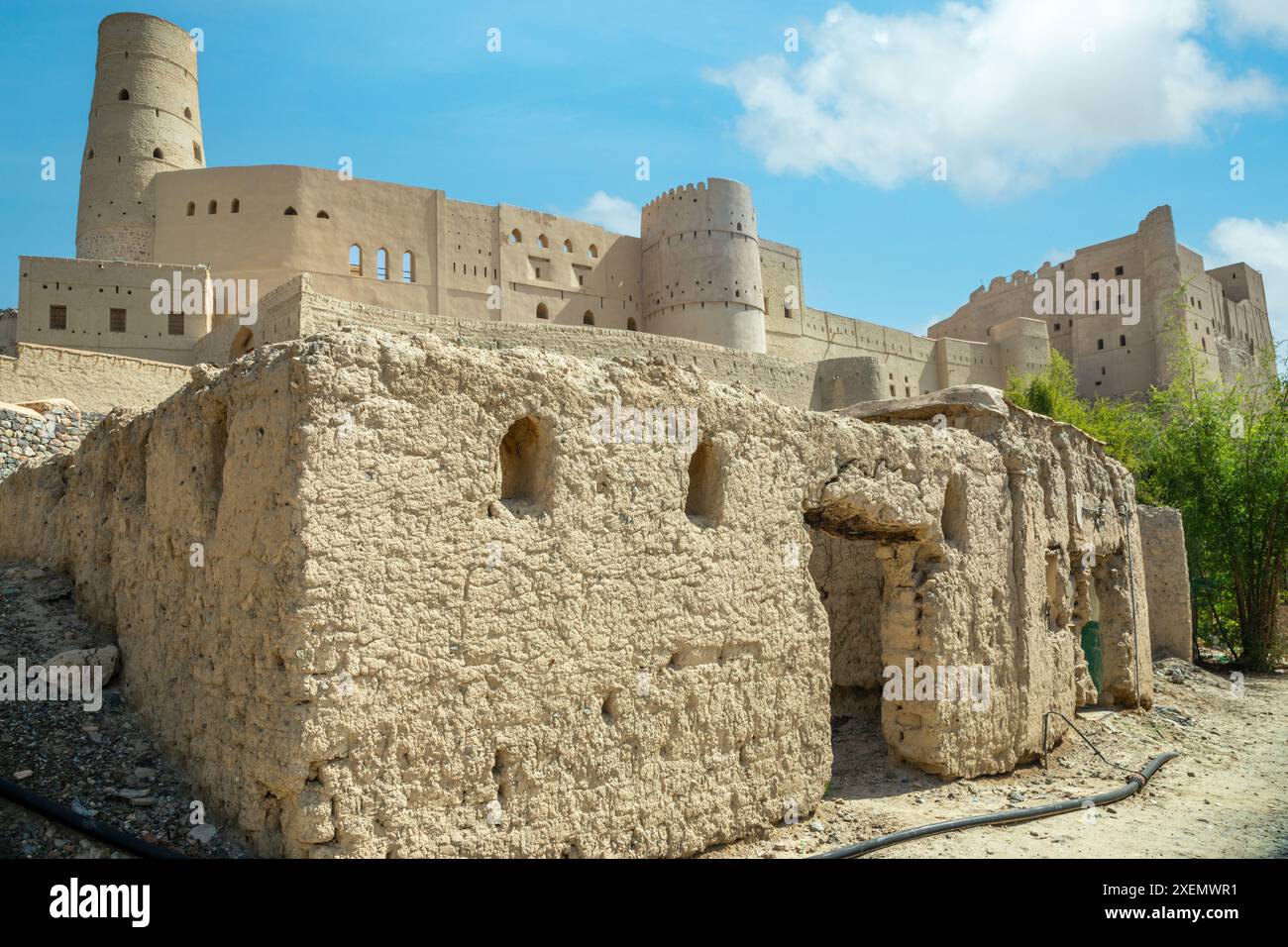 Bahla citadel fortress stone walls and round towers with old building ...