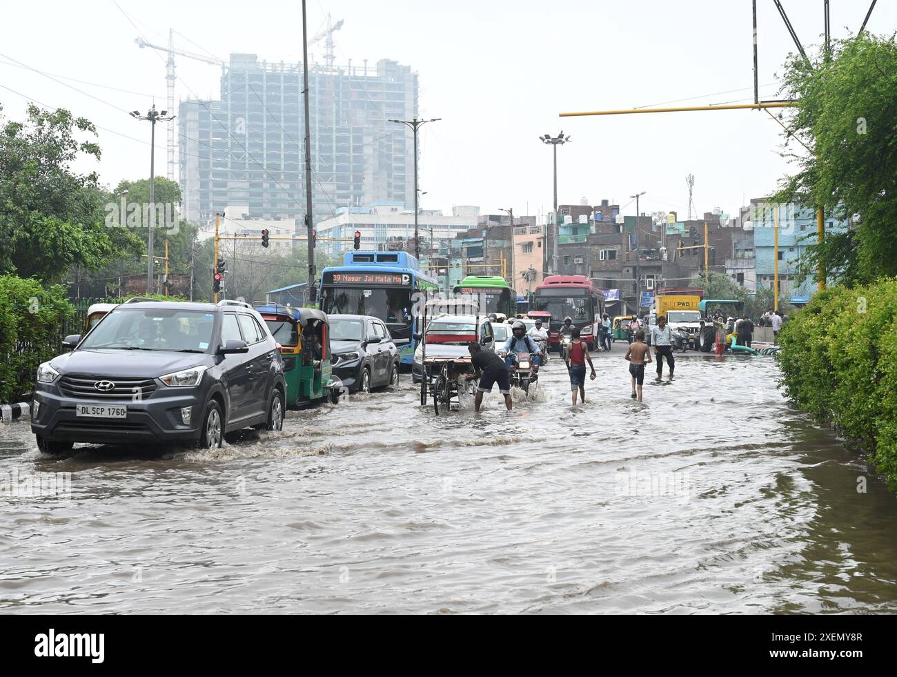 NEW DELHI, INDIA - JUNE 28: Traffic wade through waterlogged road at Jawahar Lal Nehru Marg ...