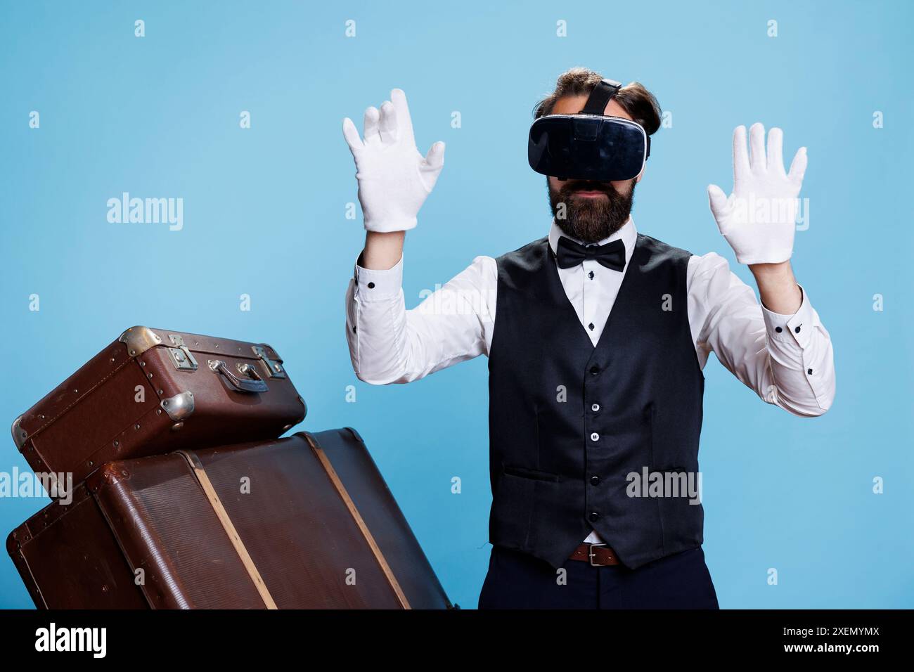 Modern doorman using vr glasses in studio, wearing formal suit and tie ...