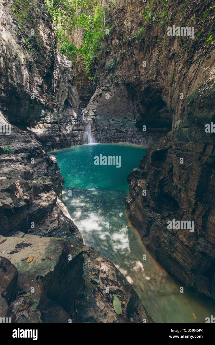 Stunning lagoon and waterfall at Air Terjun Wai Marang on the island of ...