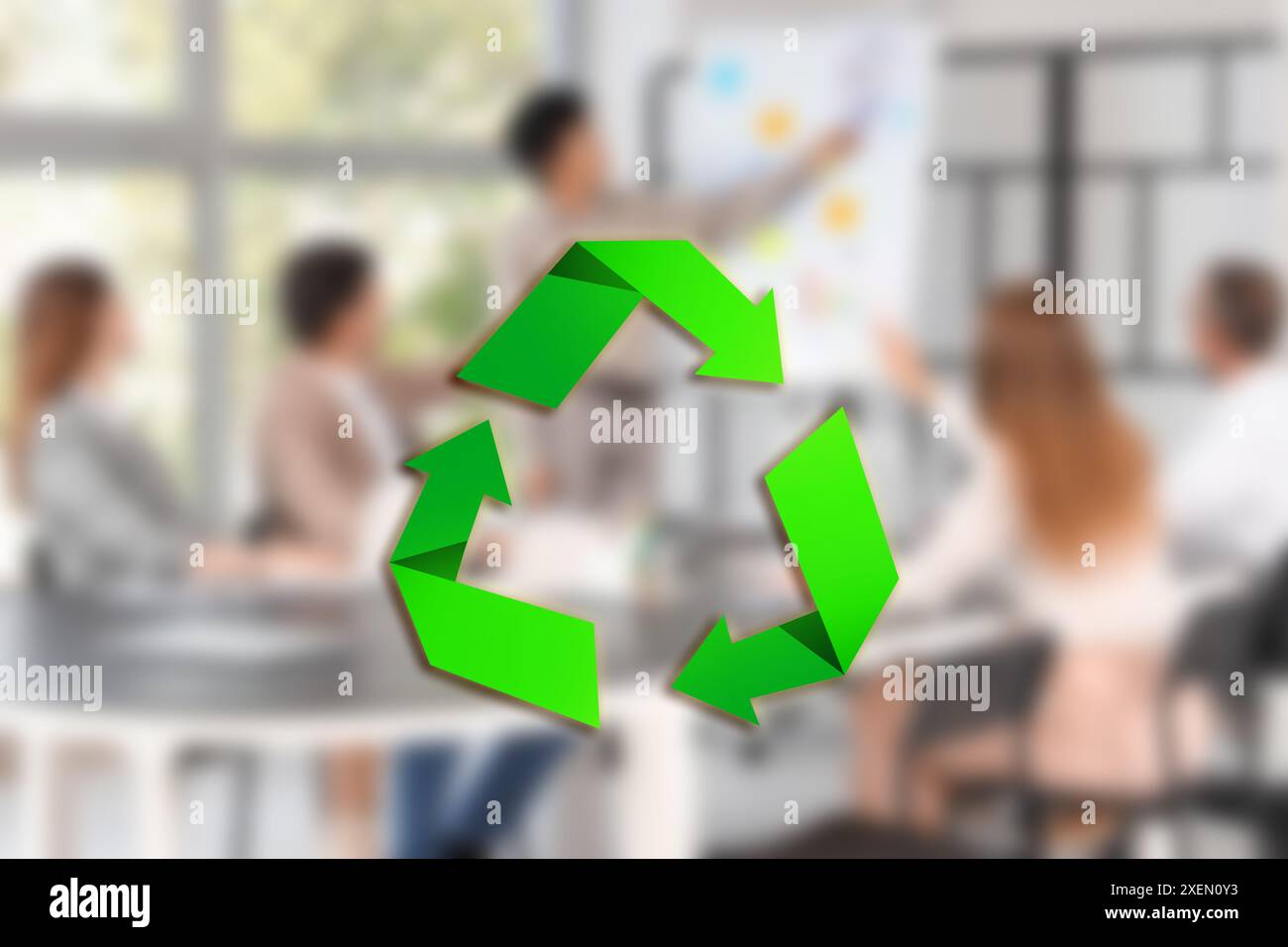 Recycling symbol and business colleagues during meeting in office Stock ...