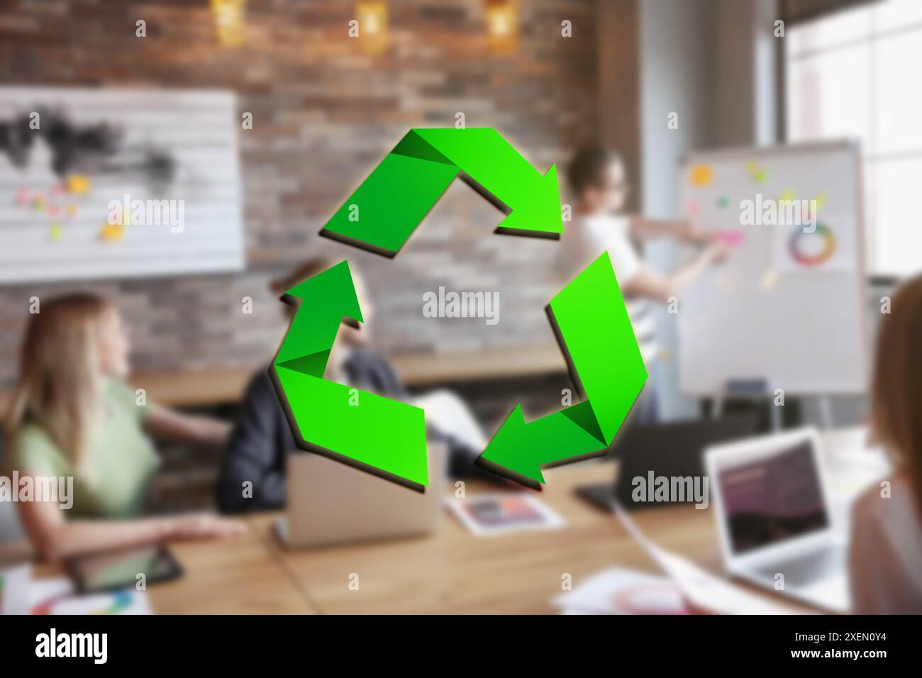 Recycling symbol and business colleagues during meeting in office Stock ...
