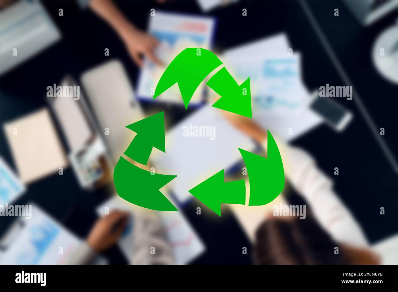 Recycling symbol and business colleagues at table in office Stock Photo ...