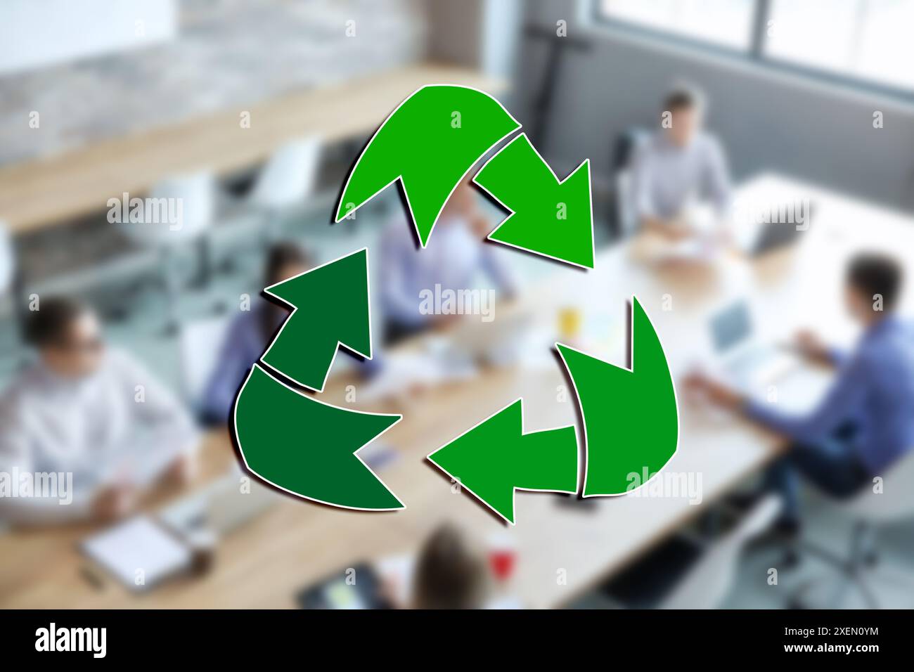 Recycling symbol and business colleagues during meeting in office Stock ...