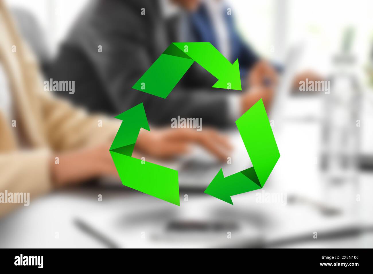Recycling symbol and business colleagues at table in office Stock Photo ...