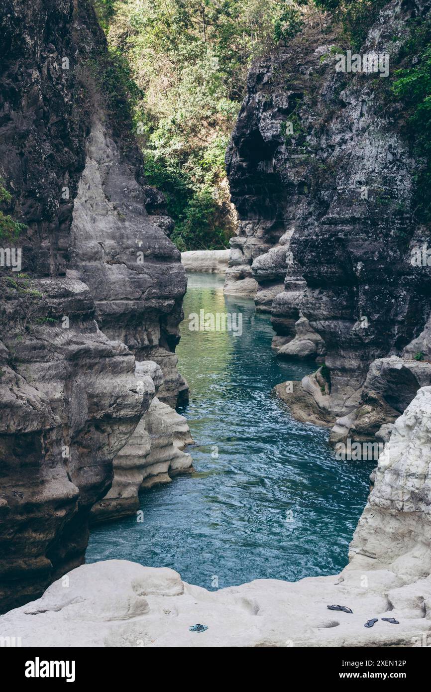 Tranquil water flows through a gorge at Air Terjun Tanggedu, Indonesia ...