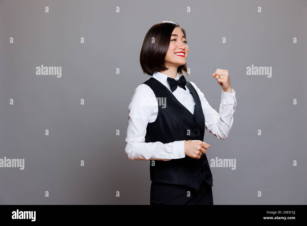 Smiling woman receptionist dancing while having fun and relaxing ...