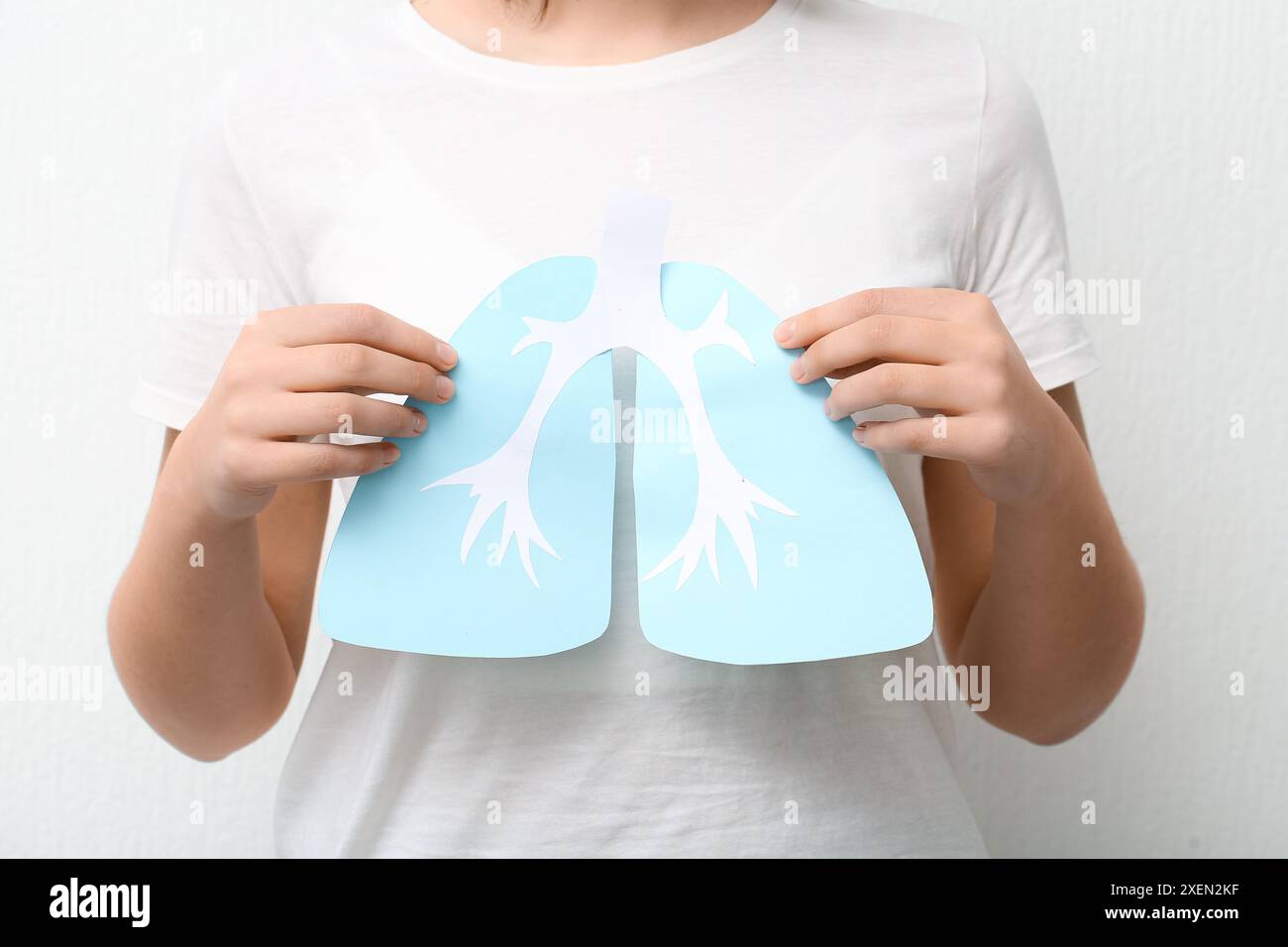 Young woman with paper lungs on white background Stock Photo - Alamy