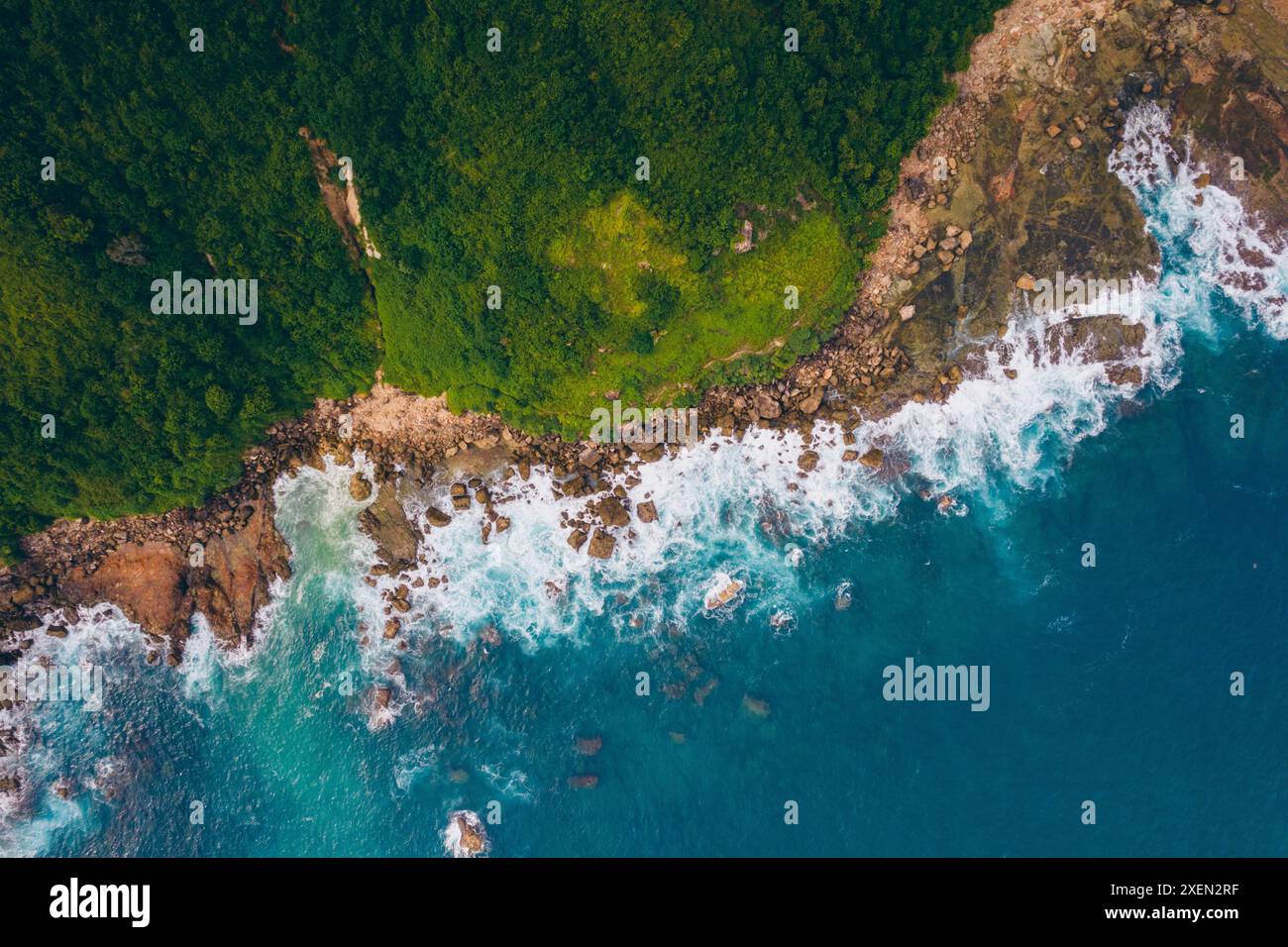 Aerial view of the rugged coastline and lush vegetation on Seger Beach ...