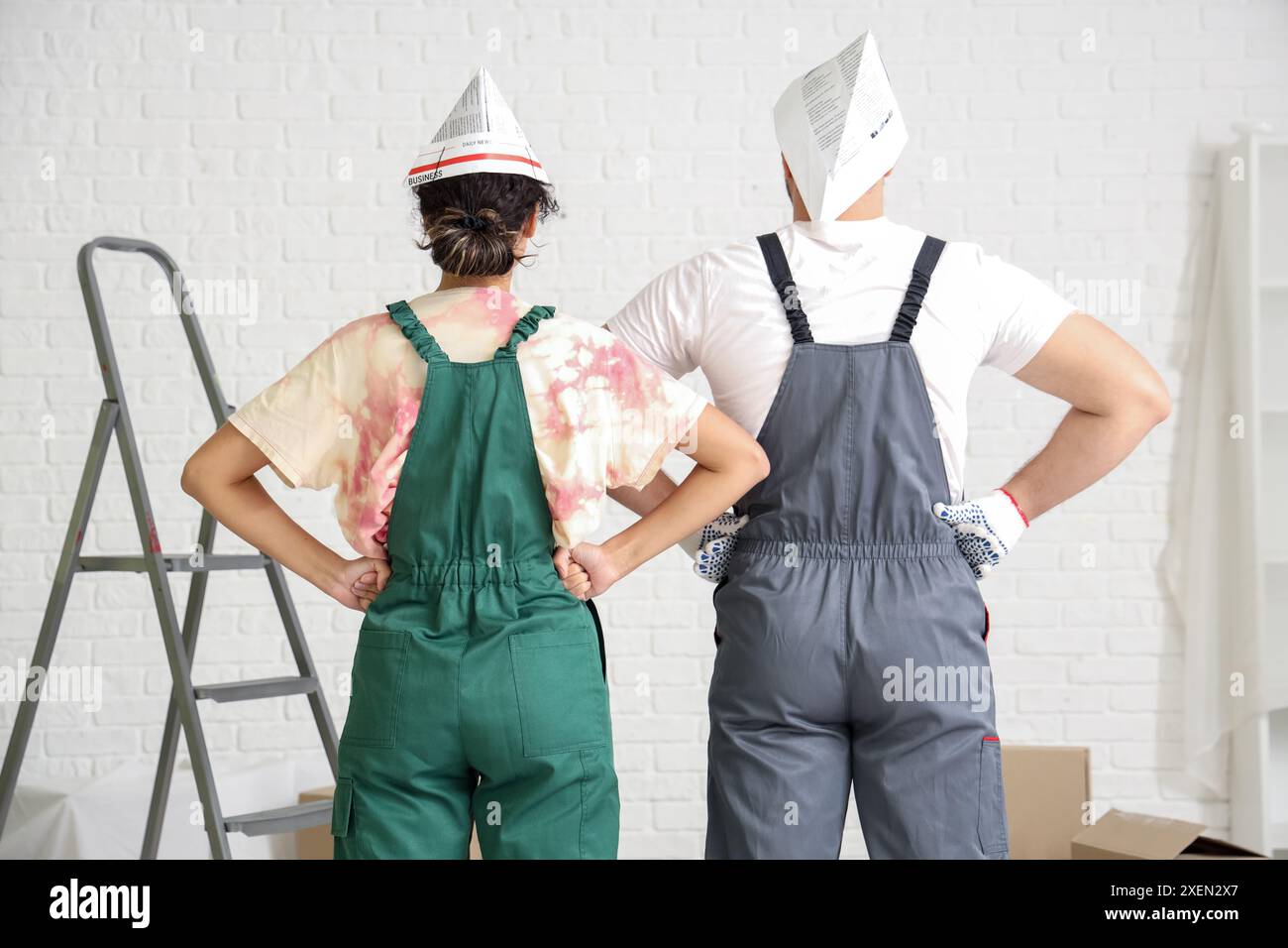 Beautiful young couple doing repair in their new house, back view Stock ...
