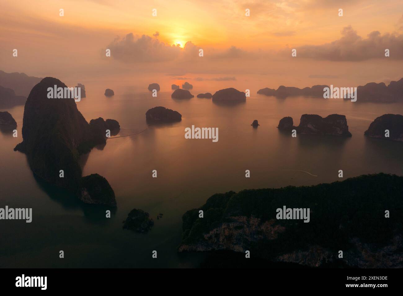 Karst rock formations and a dramatic sunrise in Ao Phang Nga National ...