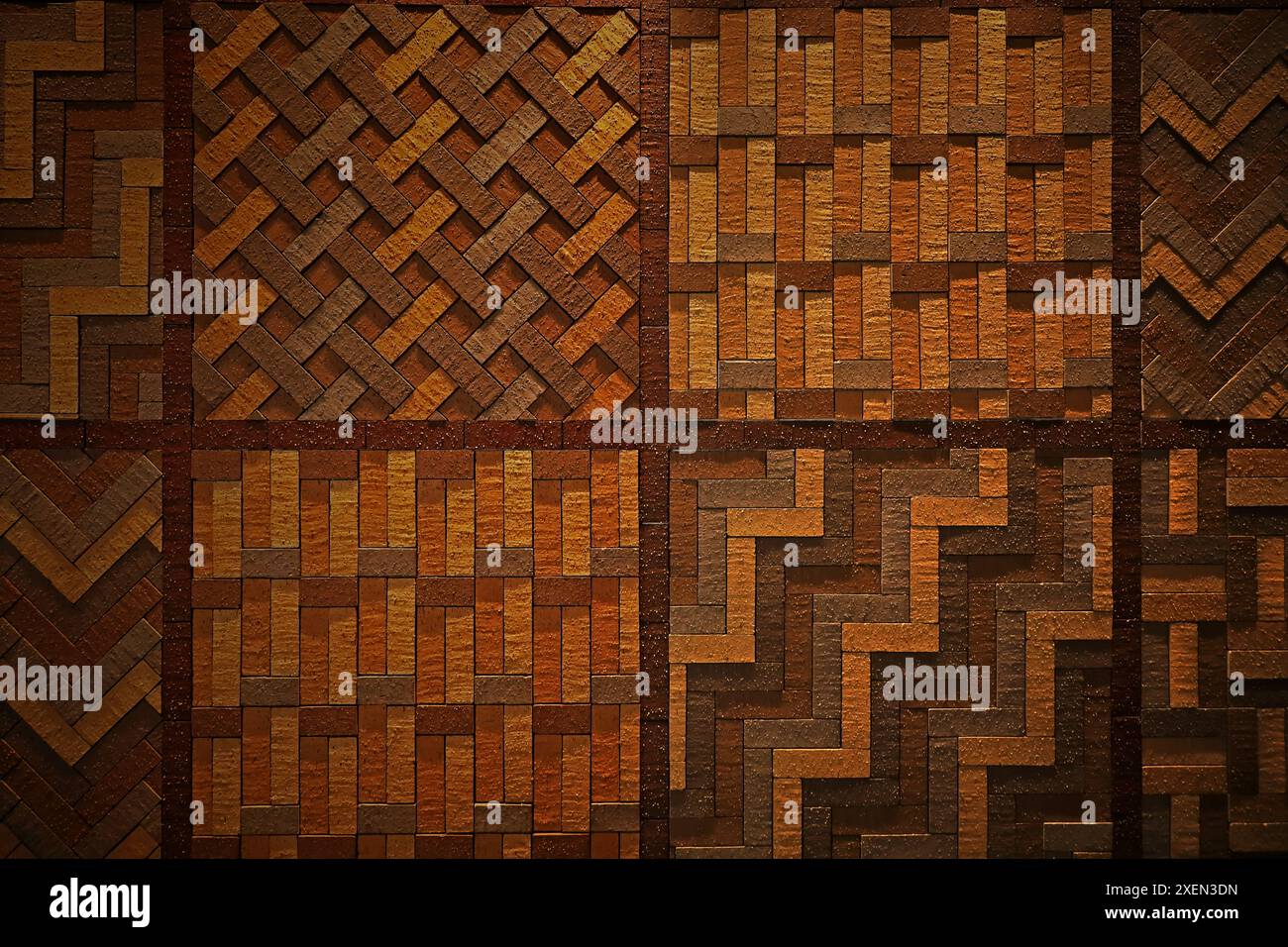 A photo of a wall designed with different colored bricks combined in various shapes for ...