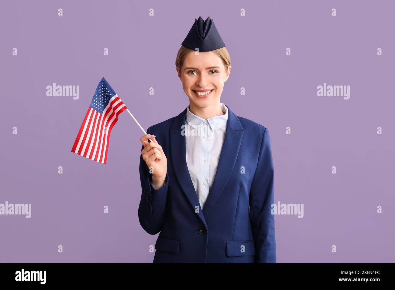 Female stewardess holding USA flag on purple background Stock Photo - Alamy