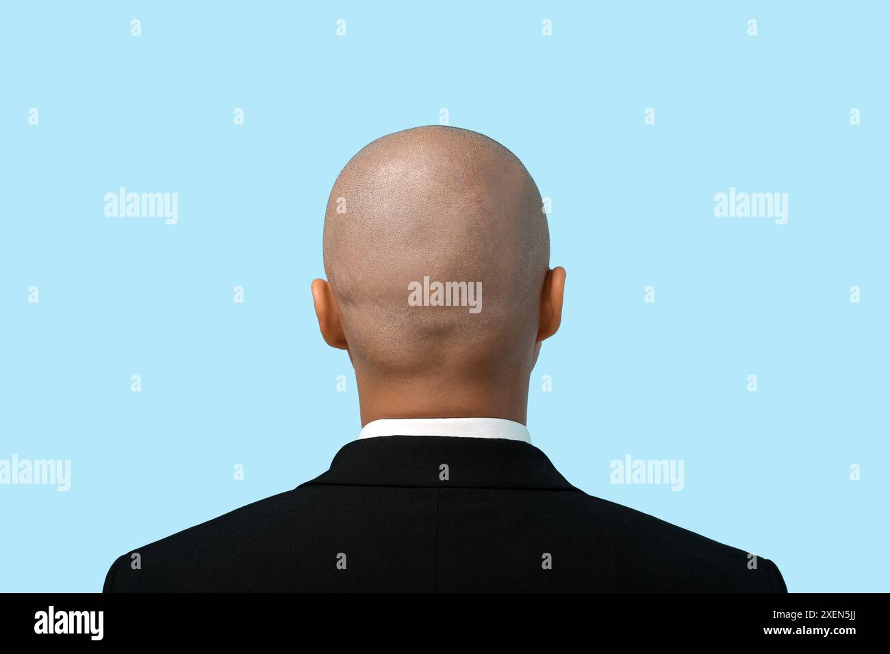 Bald businessman on blue background, back view Stock Photo - Alamy