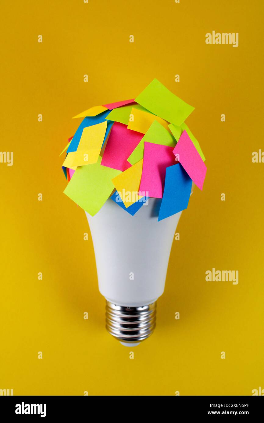 Light bulb covered with papers of different colors that express a wide ...