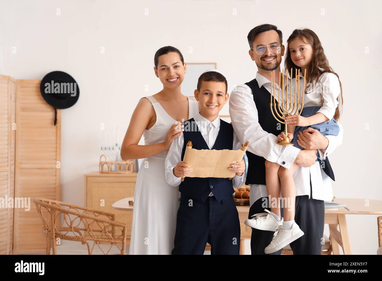 Happy Jewish family with menorah and book of Esther at home Stock Photo ...